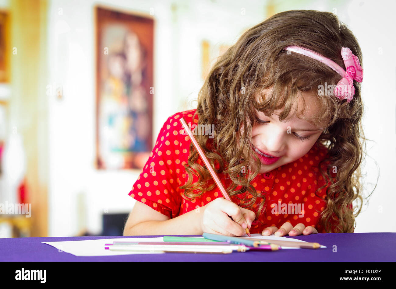 Sweet preschooler girl using colored pencils Stock Photo - Alamy