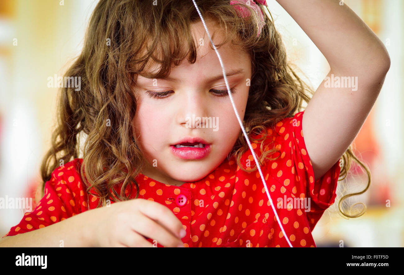Adorable little girl making crafts Stock Photo - Alamy