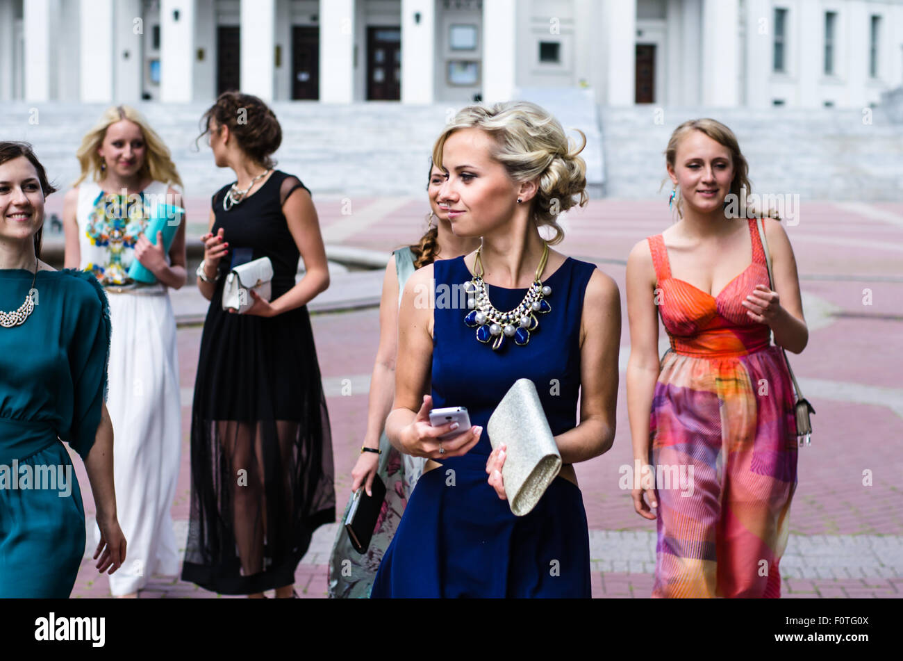 A big group of girls (females) posing in a front of a camera before ...