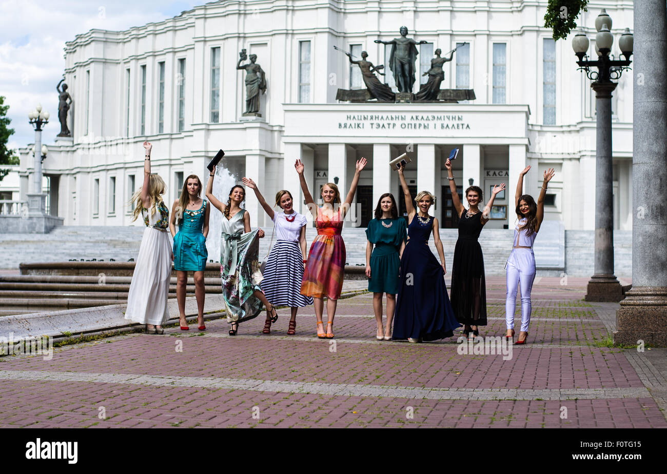A big group of girls (females) posing in a front of a camera before ...