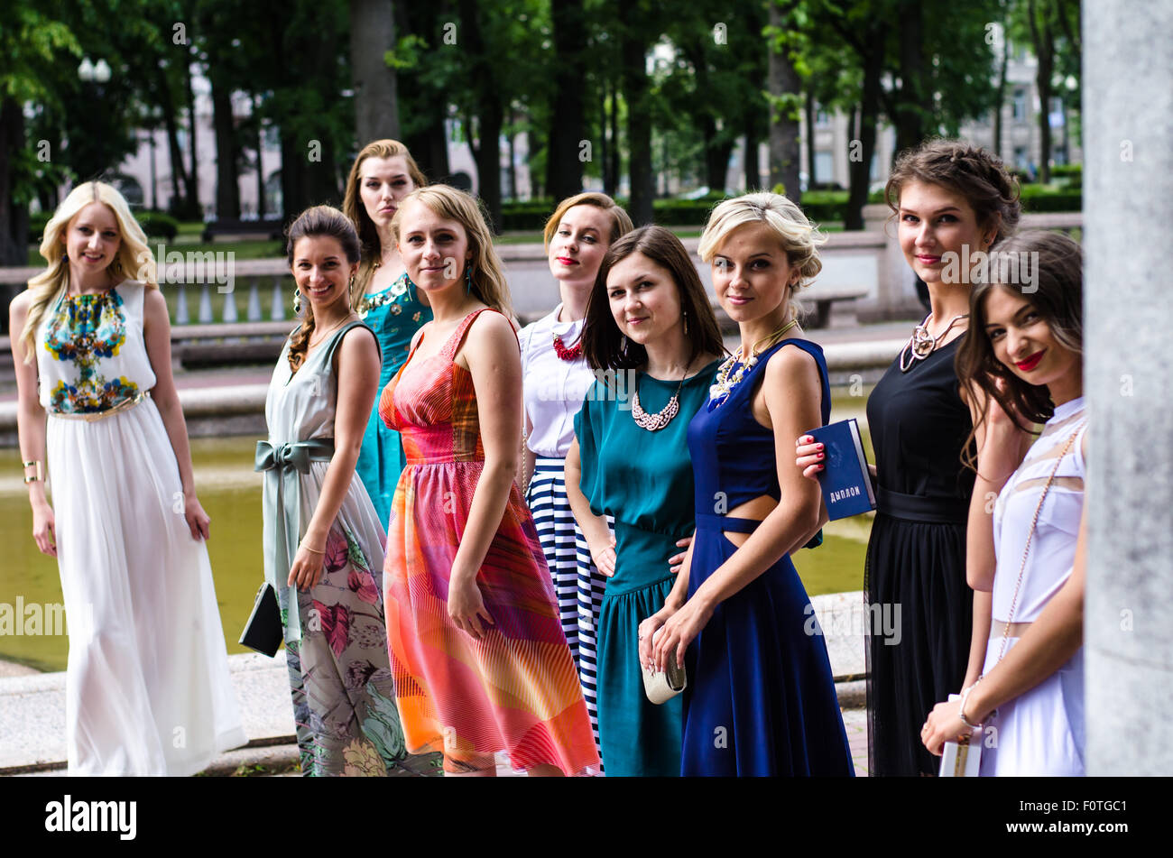 A big group of girls (females) posing in a front of a camera before ...