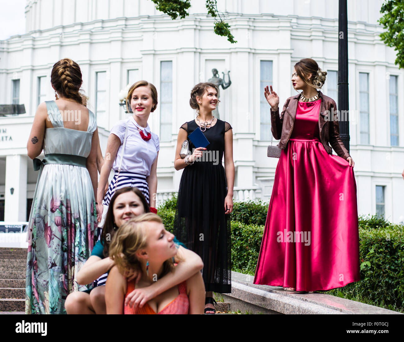 A big group of girls (females) posing in a front of a camera before ...