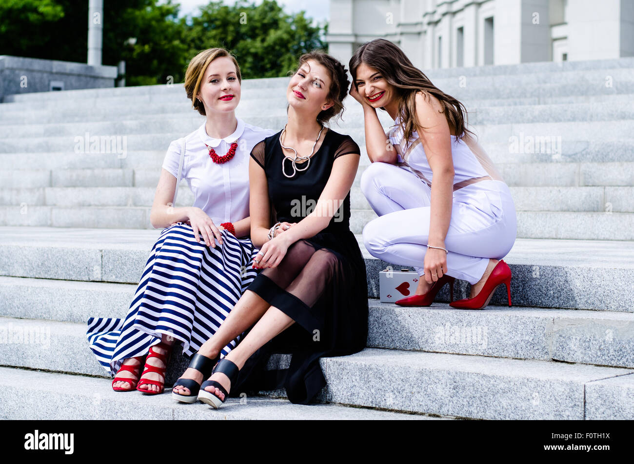 A big group of girls (females) posing in a front of a camera before ...
