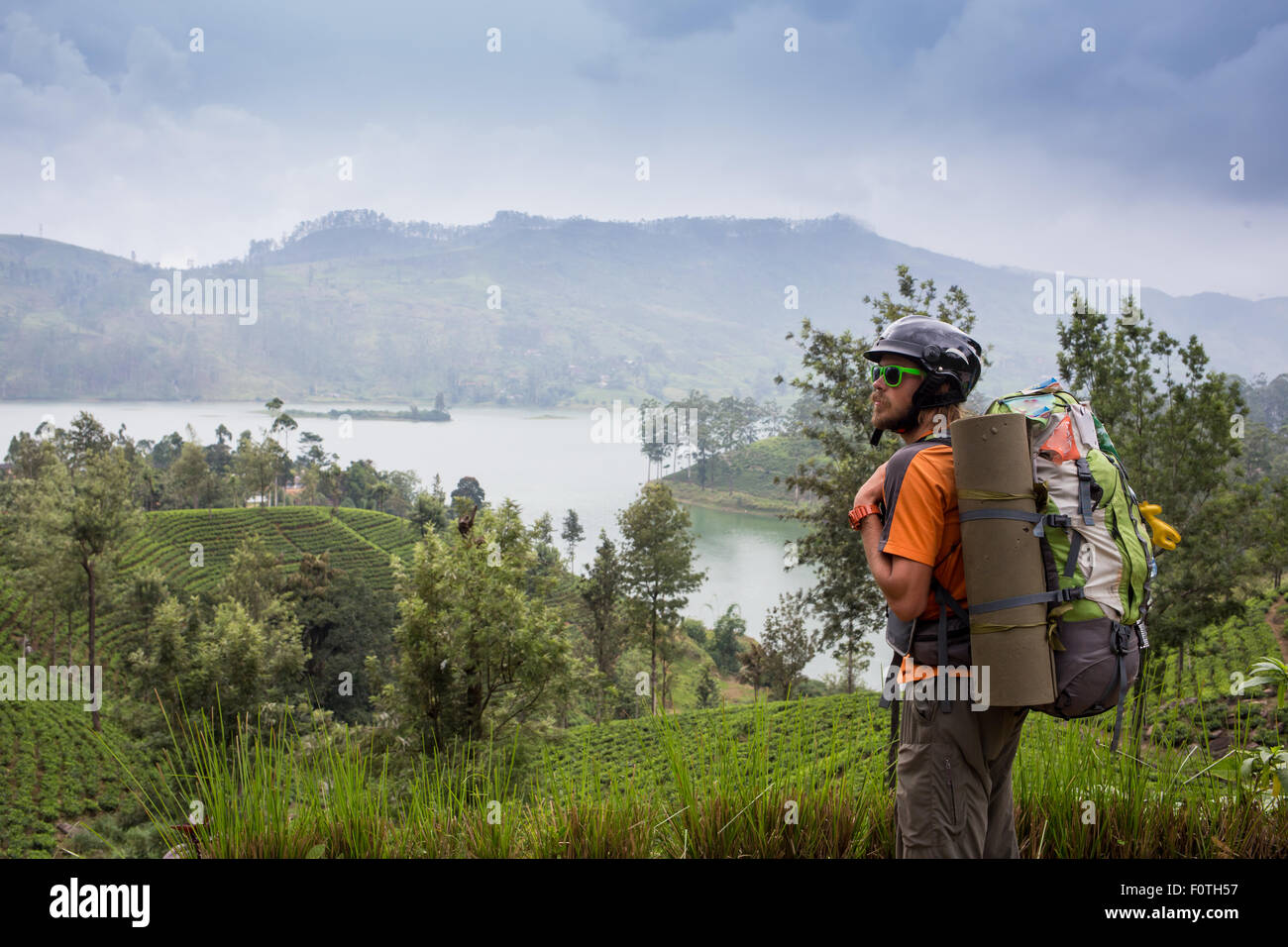 Young Man Traveler with backpack reading book Stock Photo - Alamy