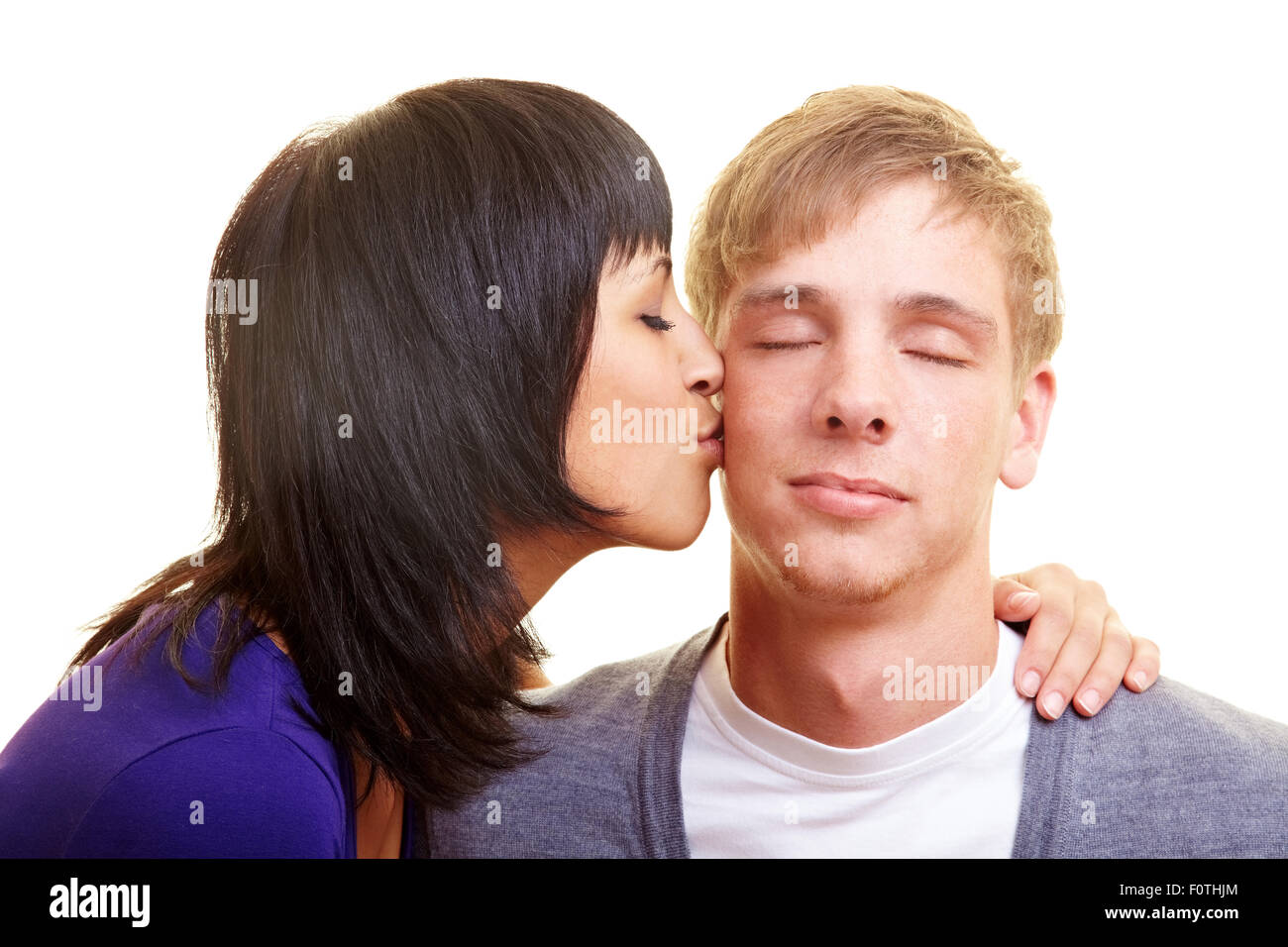 Young woman kissing her boyfriend Stock Photo - Alamy