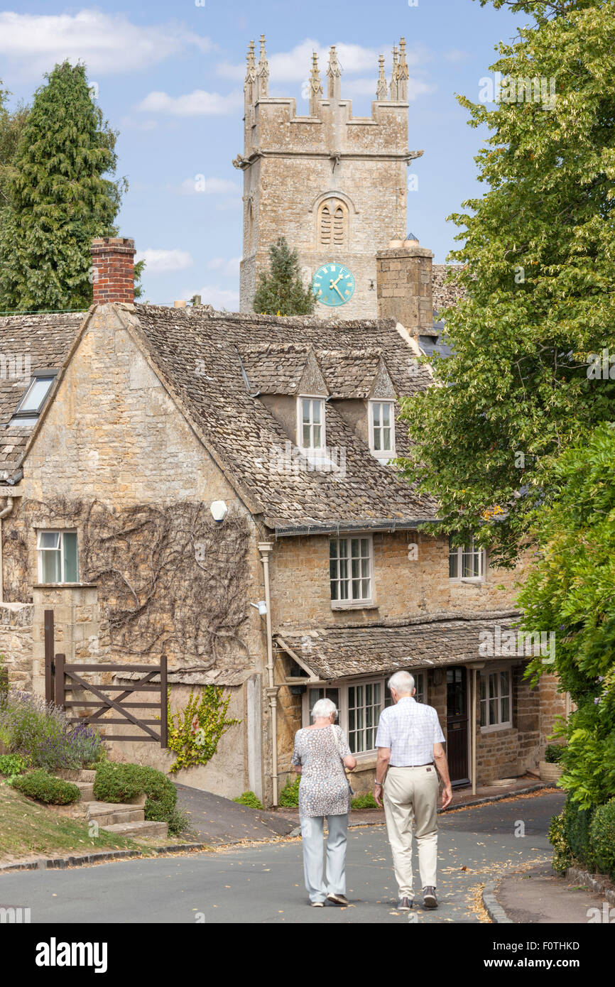 St James Church tower rises above attractive Cotswold cottages in ...