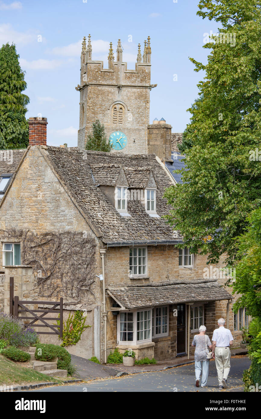 St James Church tower rises above attractive Cotswold cottages in ...