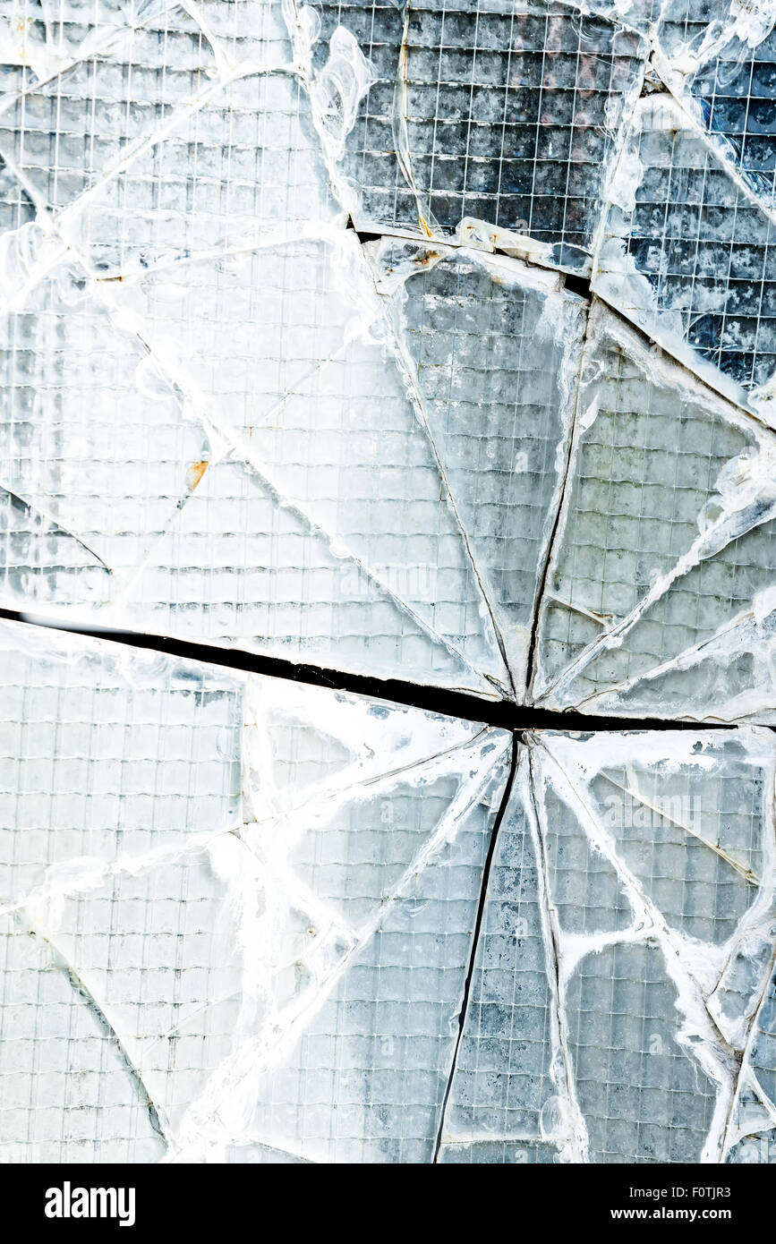 A broken industrial security window Stock Photo - Alamy