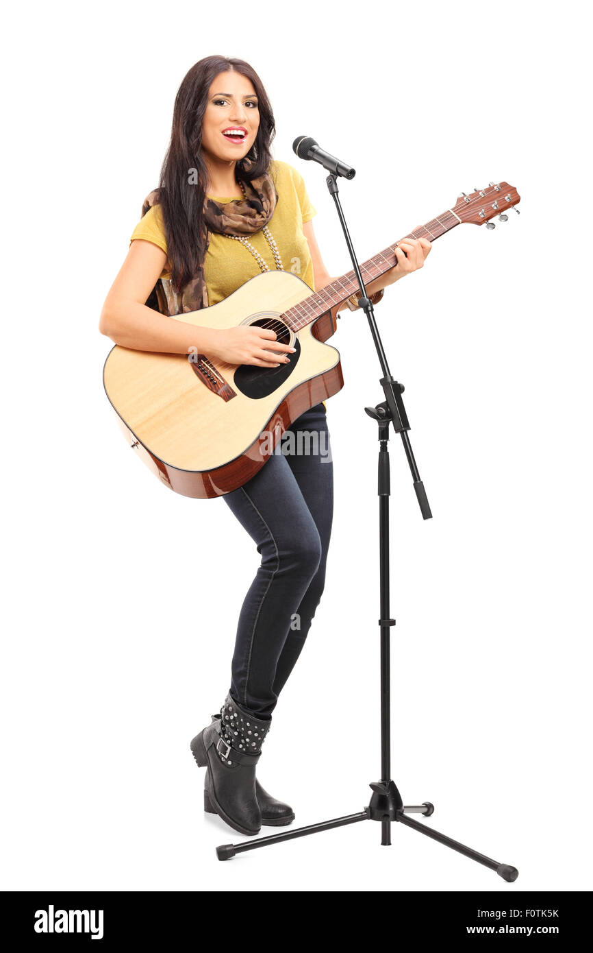 Full length portrait of a female signer playing on acoustic guitar and ...