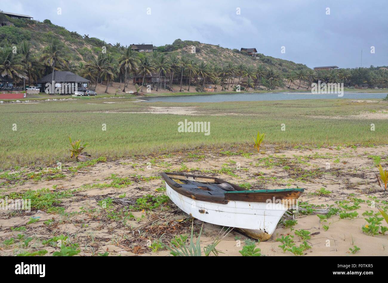 Old dilapidated fishing boats lying on the beach at Inhambane ...