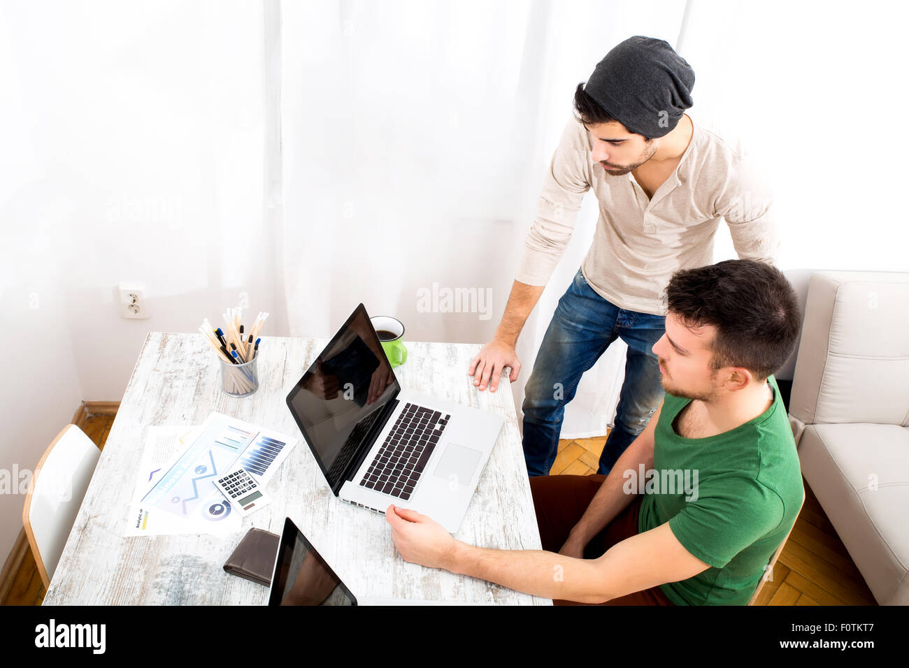 Two young colleagues discussing something in the office Stock Photo - Alamy