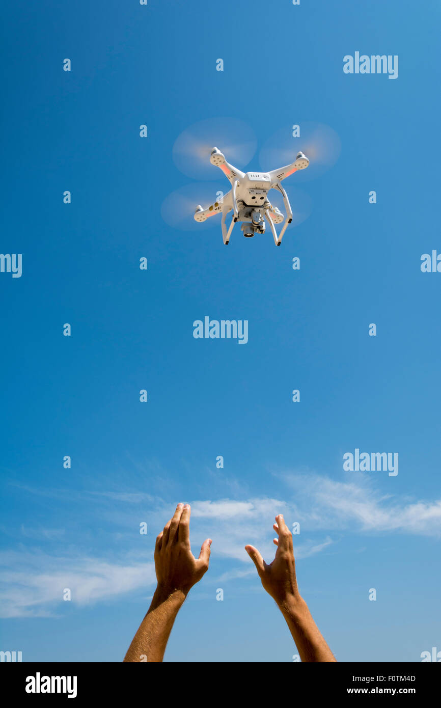 Person reaches up to catch a drone Stock Photo - Alamy