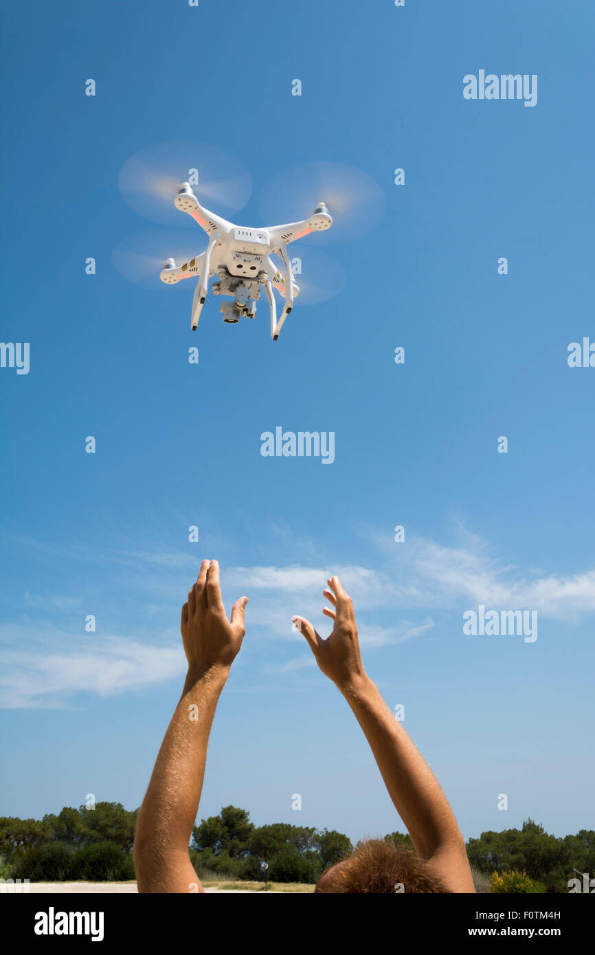 Person reaches up to catch a drone Stock Photo - Alamy