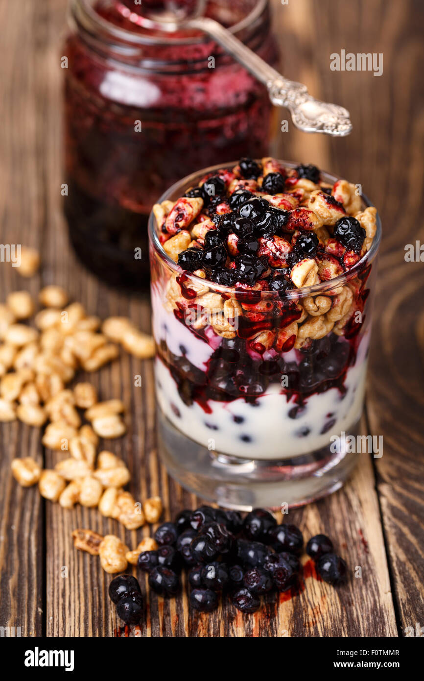 Parfait-style healthy layered snack or dessert with yogurt,bilberry jam ...