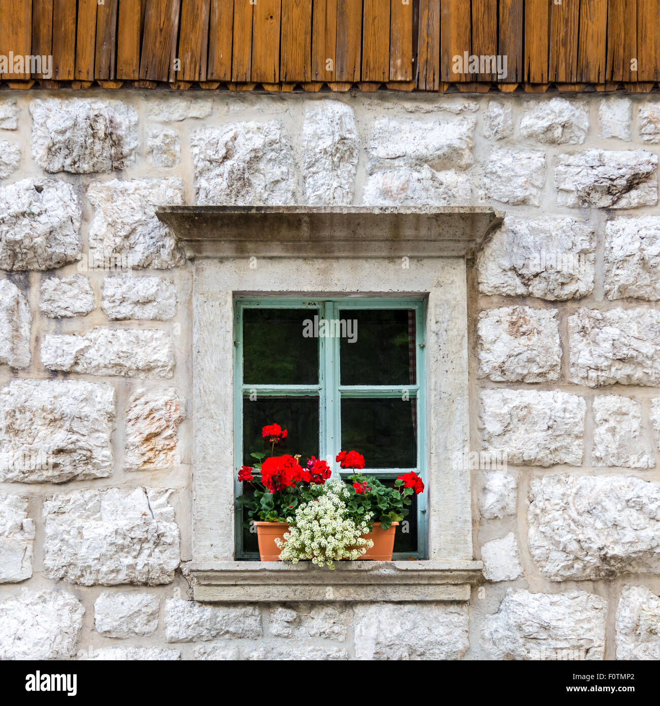 Traditional alpine stone window Stock Photo - Alamy