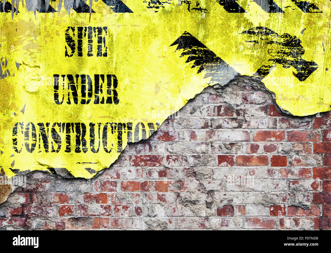 Grungy old brick wall with site under construction sign on broken ...