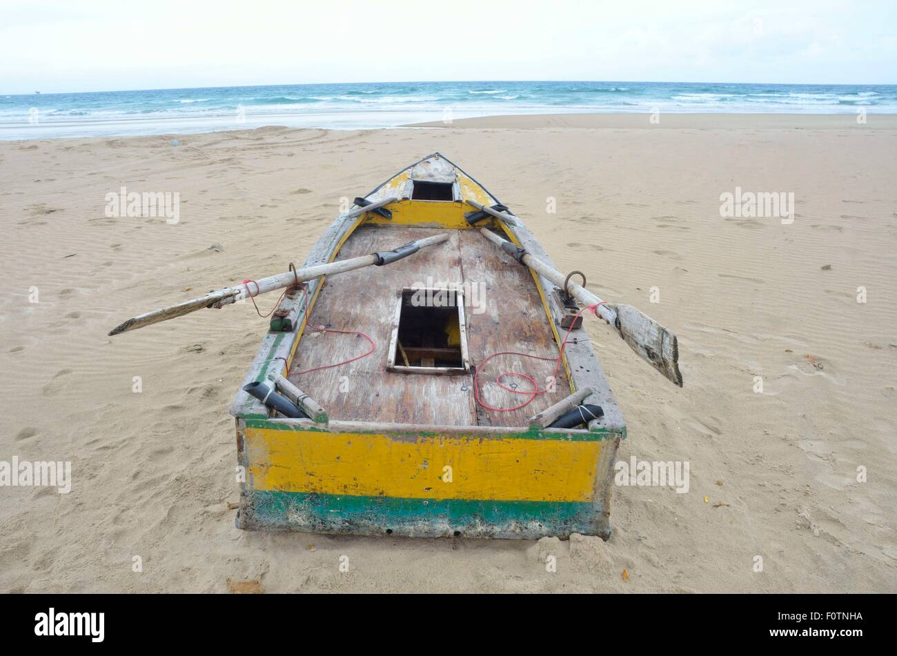 Old dilapidated fishing boats lying on the beach at Inhambane ...