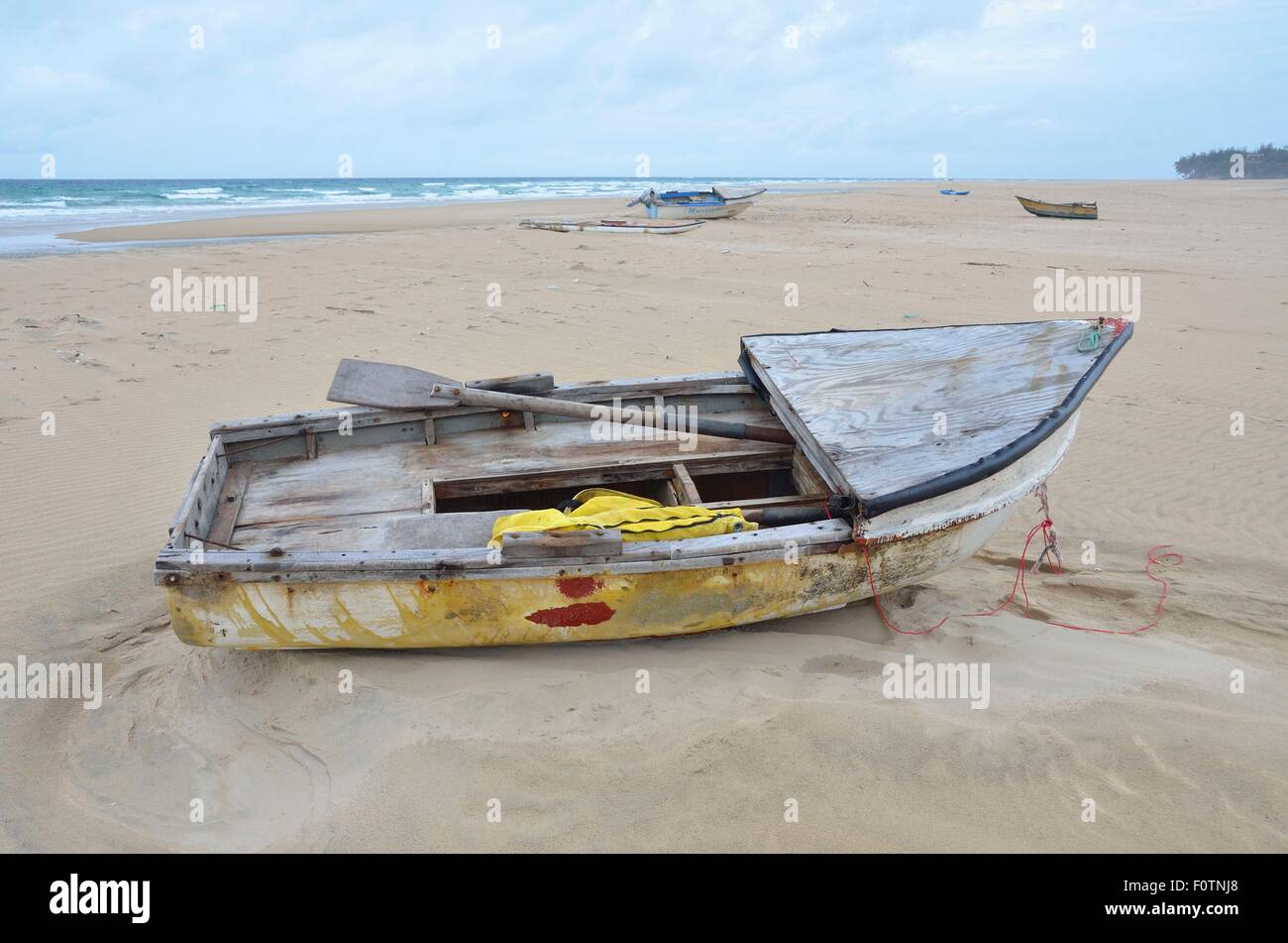 This old, unsafe fishing boat lying on the beach at Inhambane ...