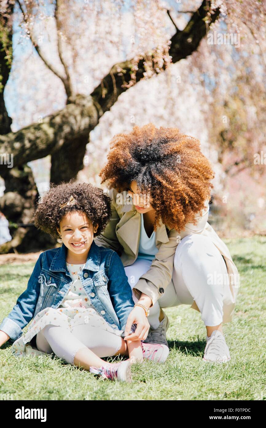 Mother daughter sitting on grass hi-res stock photography and images ...