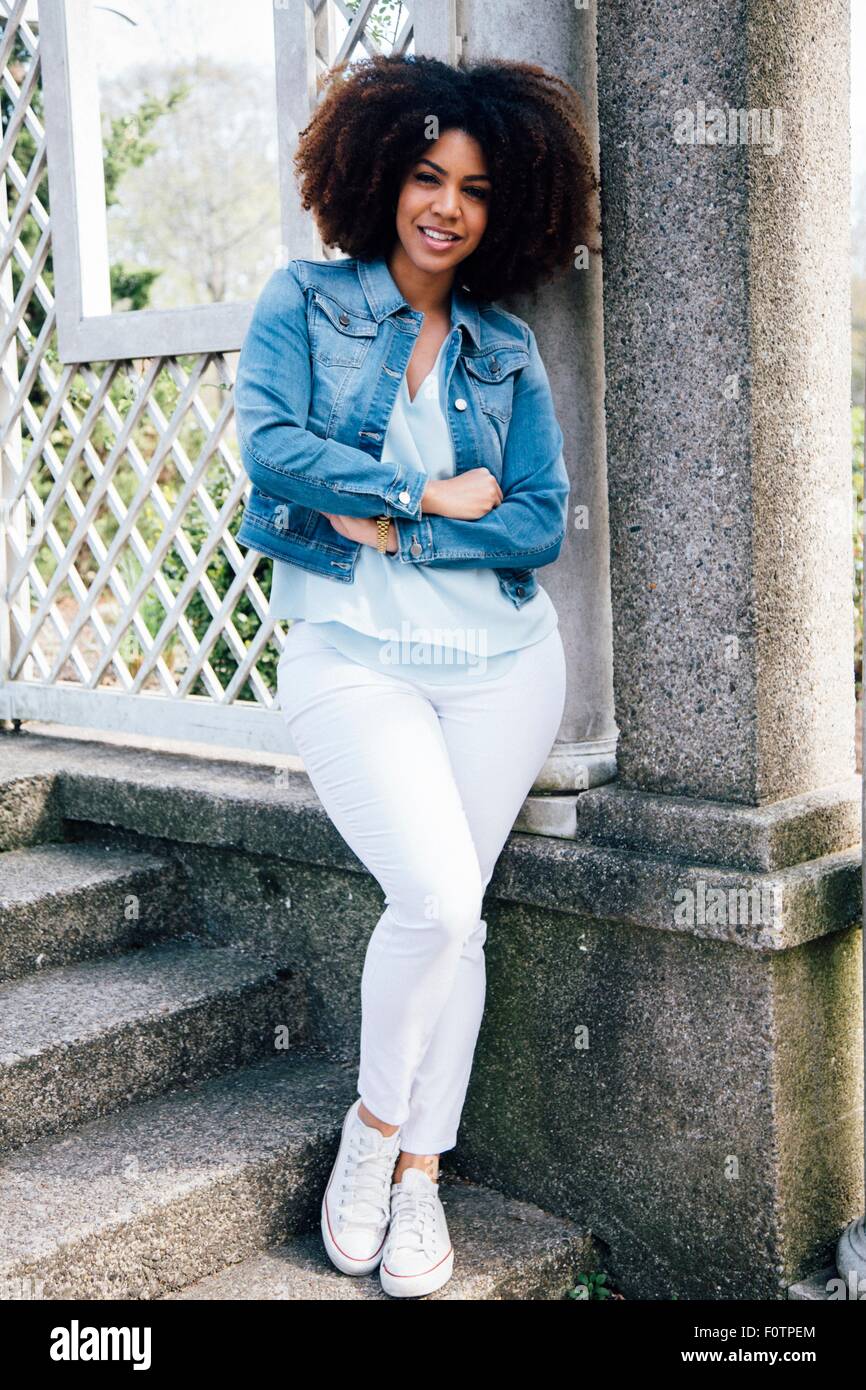 Full Length Front View Of Mid Adult Woman Arms Crossed Leaning