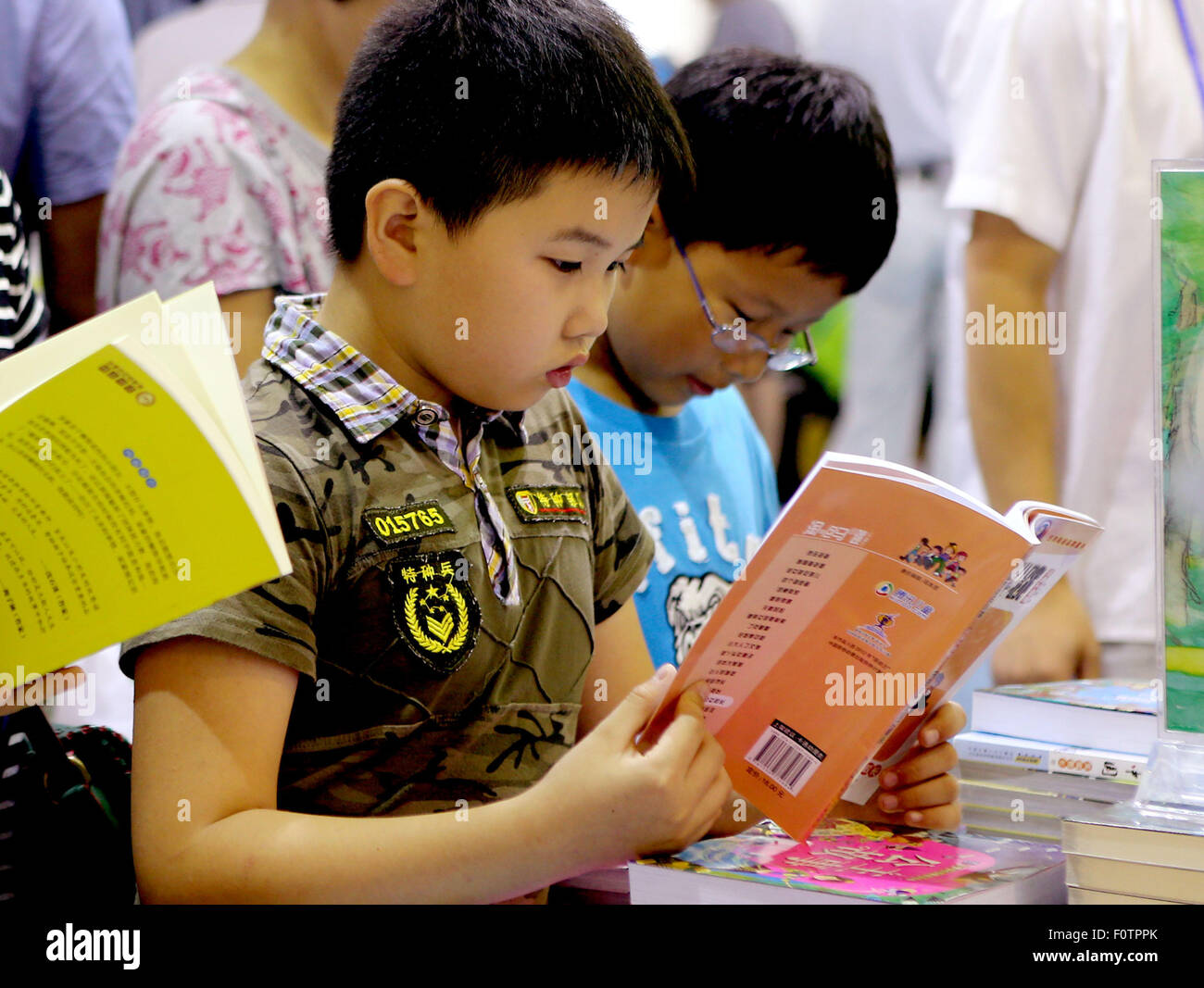 Shanghai, China. 21st Aug, 2015. Two boys read books at the 2015 ...