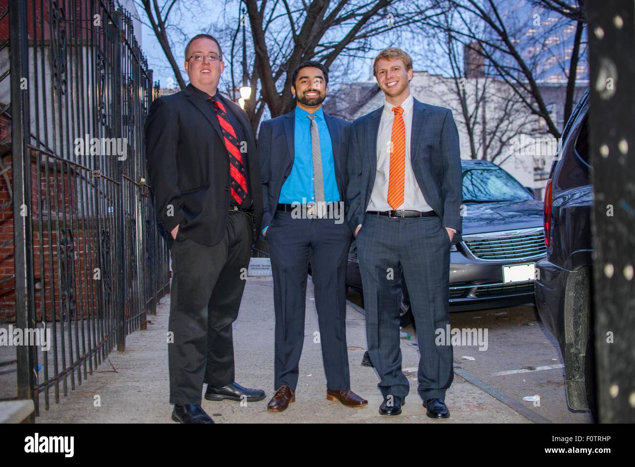 Portrait of three young male friends wearing suits for night out Stock ...