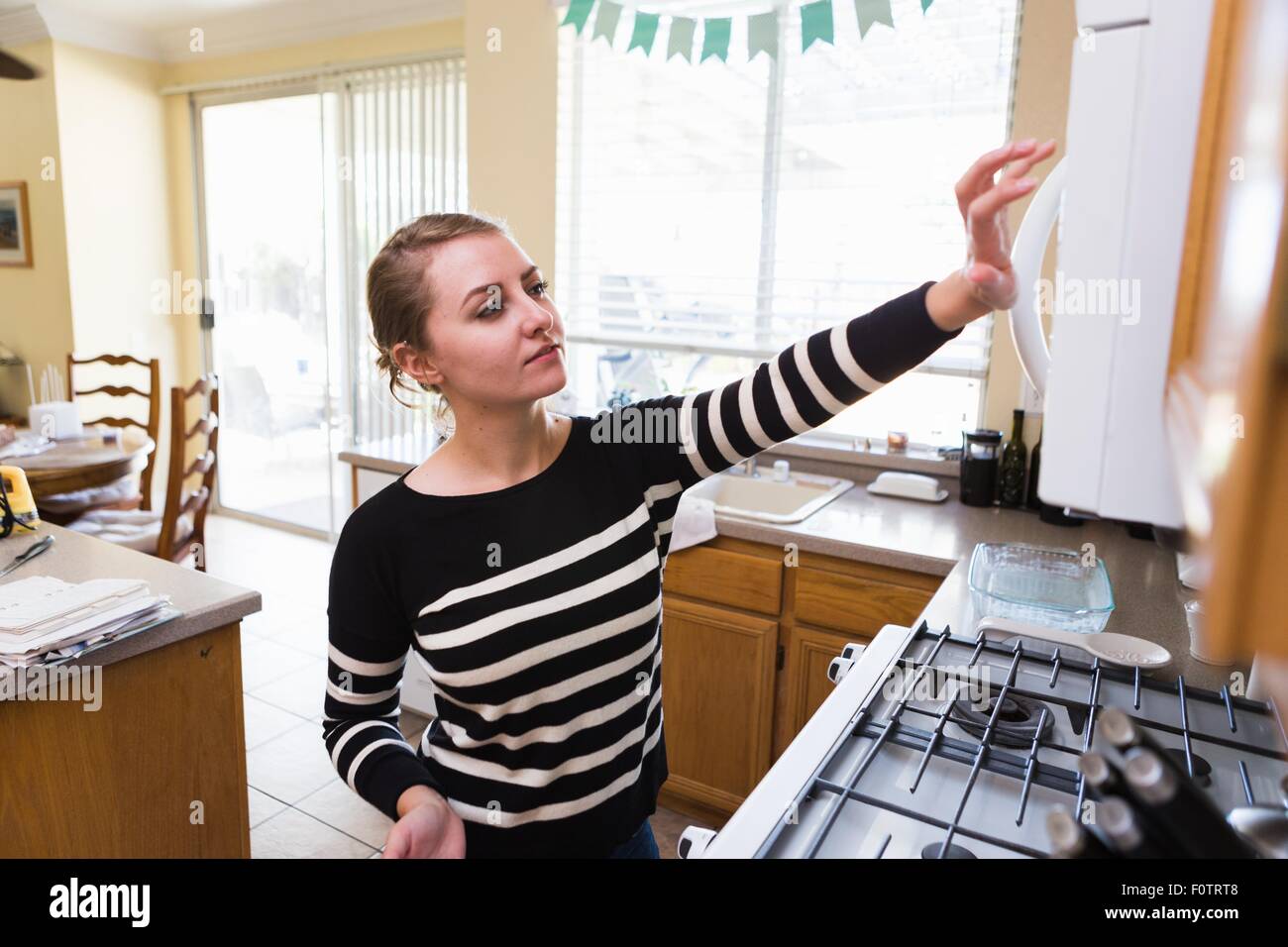 Woman working in kitchen Stock Photo - Alamy