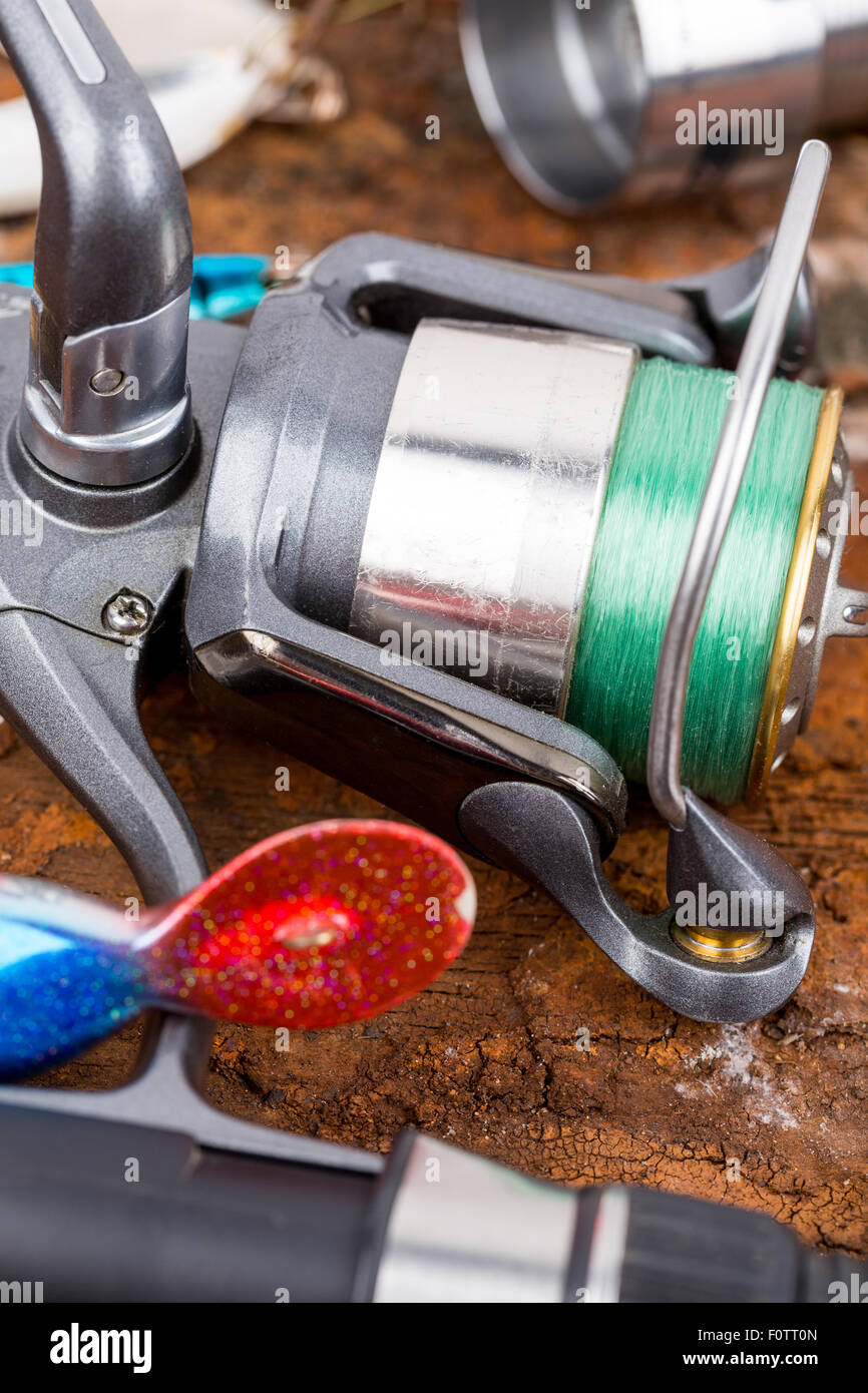 fishing reel with line on natural background Stock Photo - Alamy
