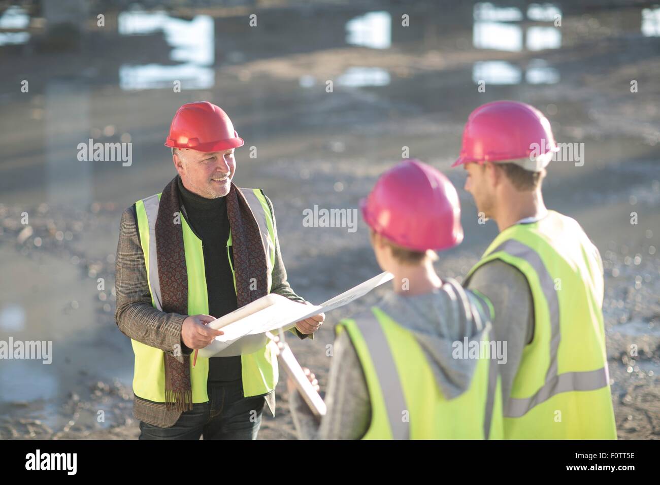 Architect meeting with builders on construction site Stock Photo - Alamy