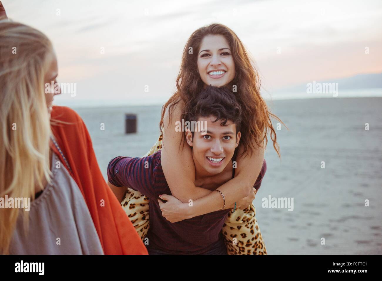 Man carrying woman on back on beach hi-res stock photography and images ...