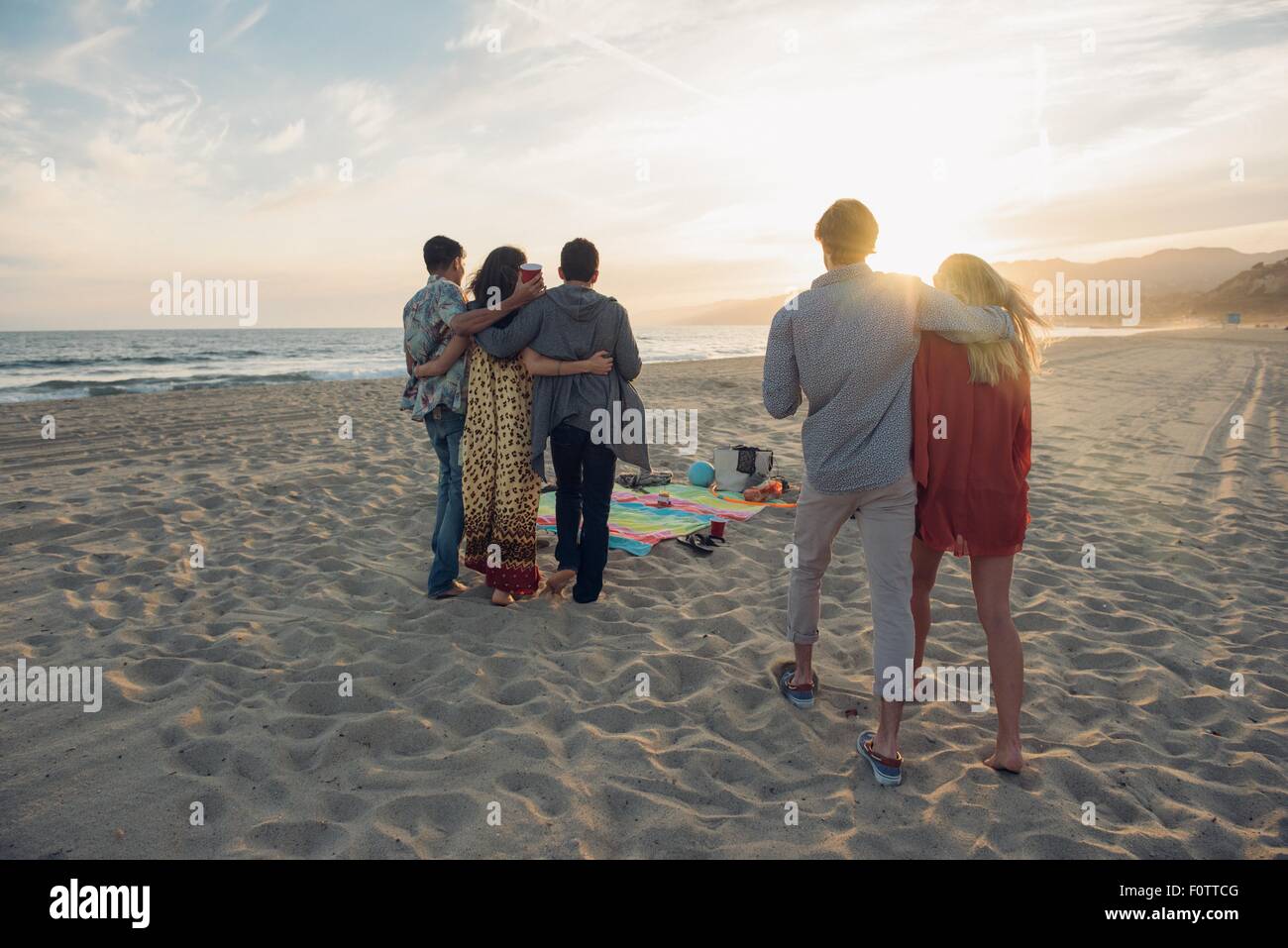 Group of friends hugging at the beach hi-res stock photography and ...