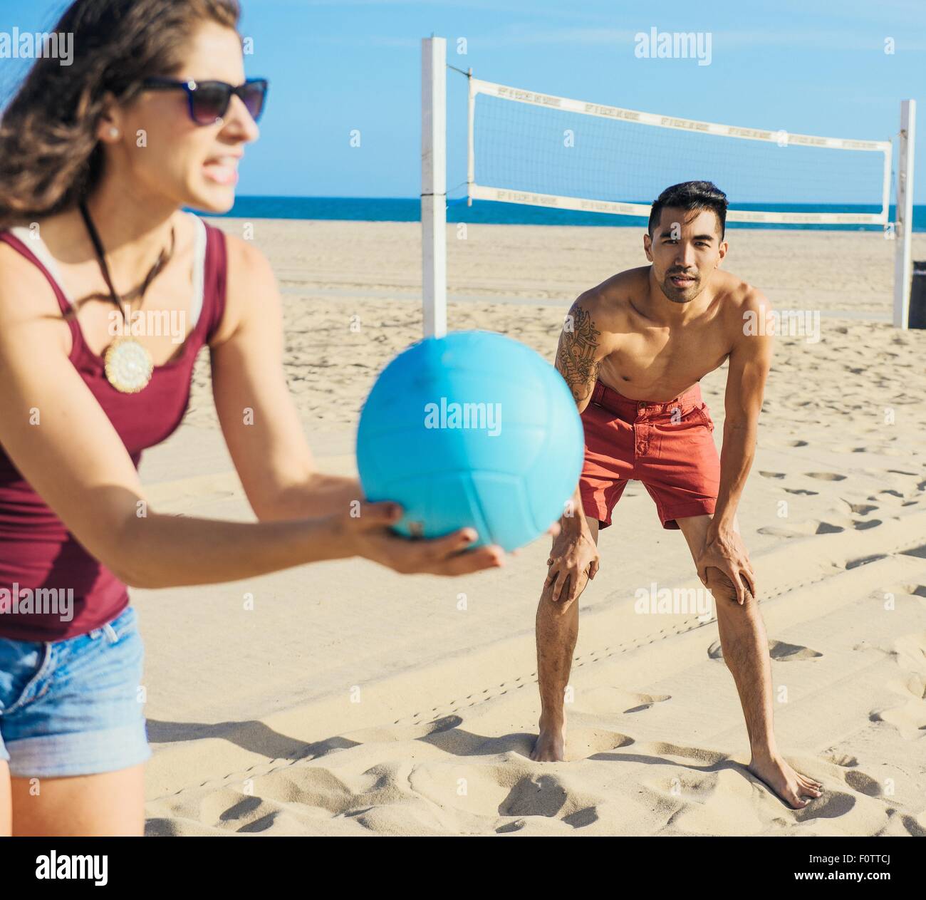 Group of friends playing volleyball on beach Stock Photo - Alamy