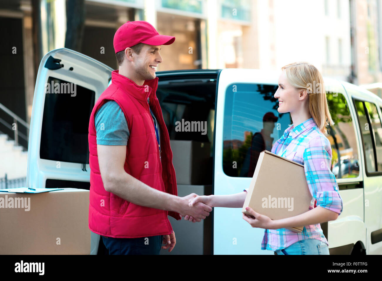 First class delivery service. Courier Delivering Package By Van Stock ...