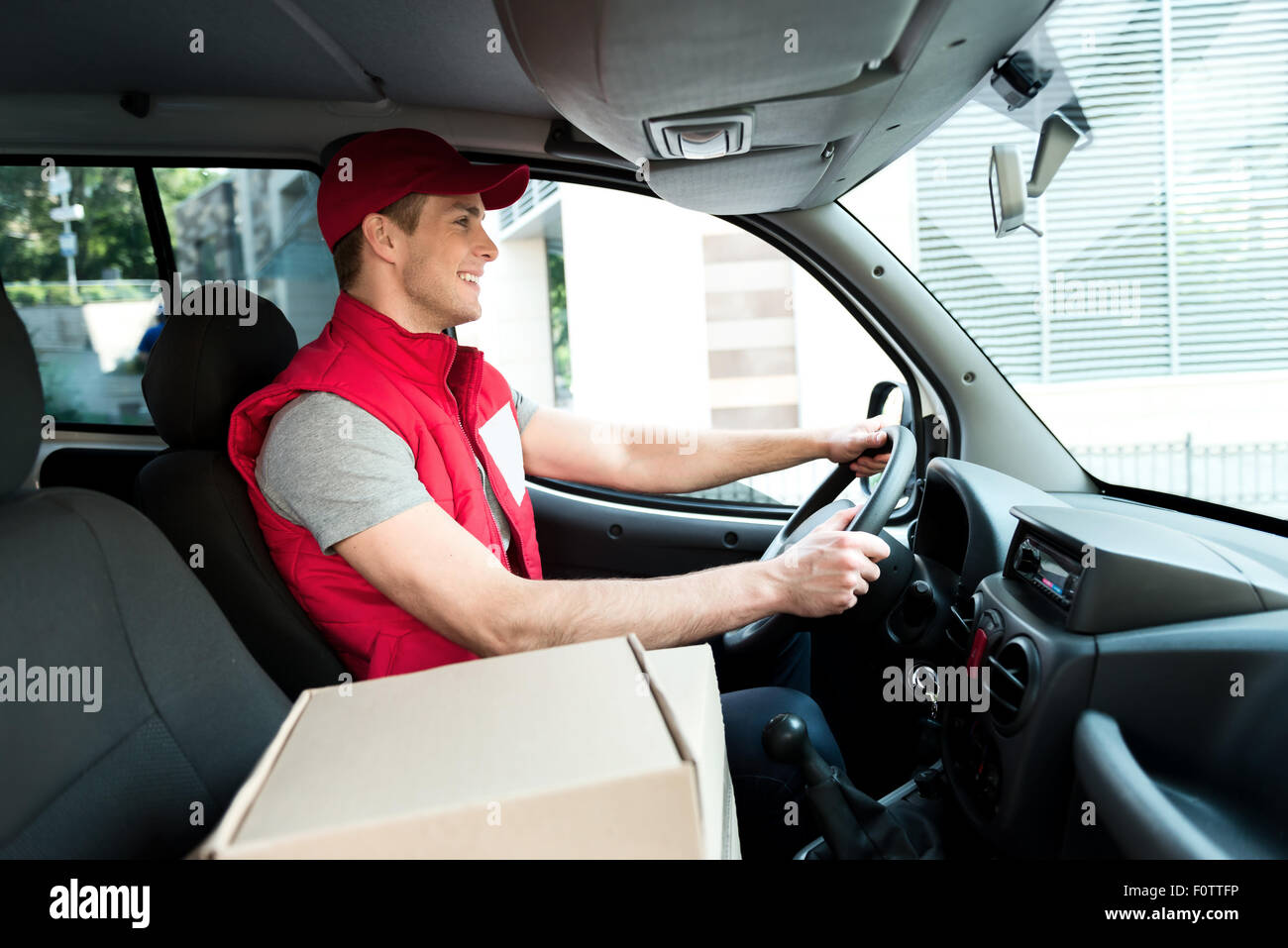 Courier Delivering Package By Van Stock Photo - Alamy