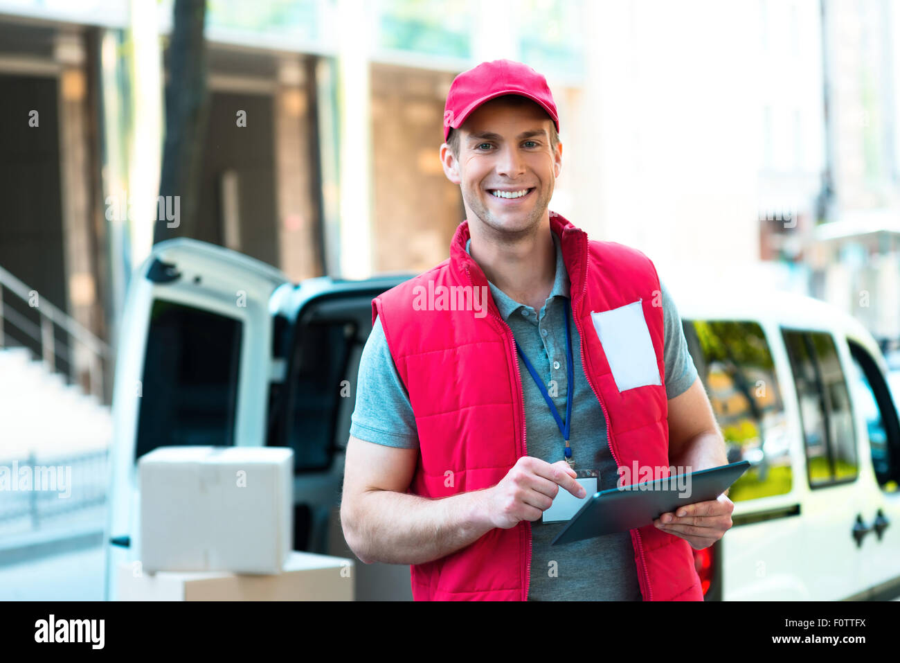 Courier Delivering Package By Van Stock Photo - Alamy