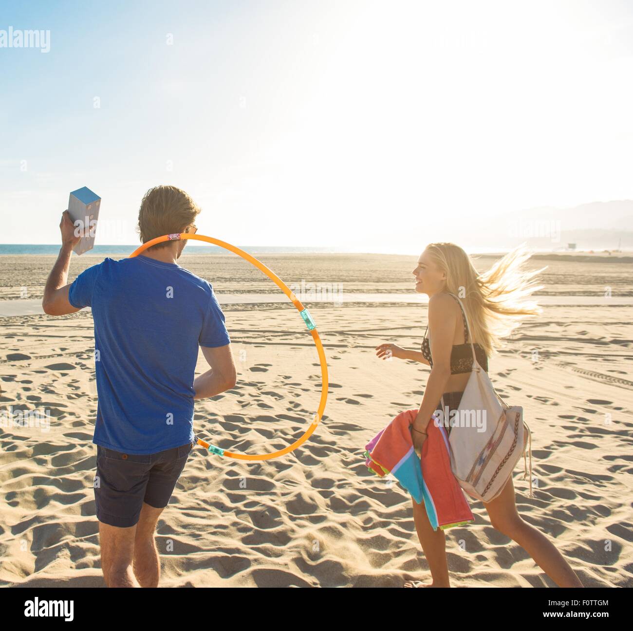 Young couple walking on beach, rear view Stock Photo - Alamy