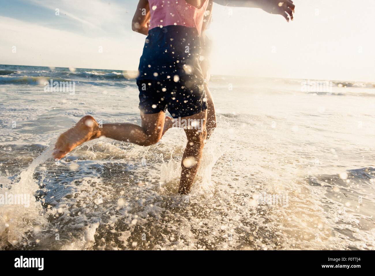 Man running from wave hi-res stock photography and images - Alamy