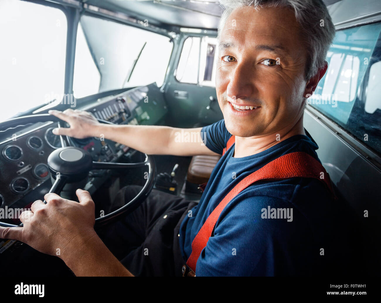 Happy Firefighter Driving Firetruck Stock Photo - Alamy
