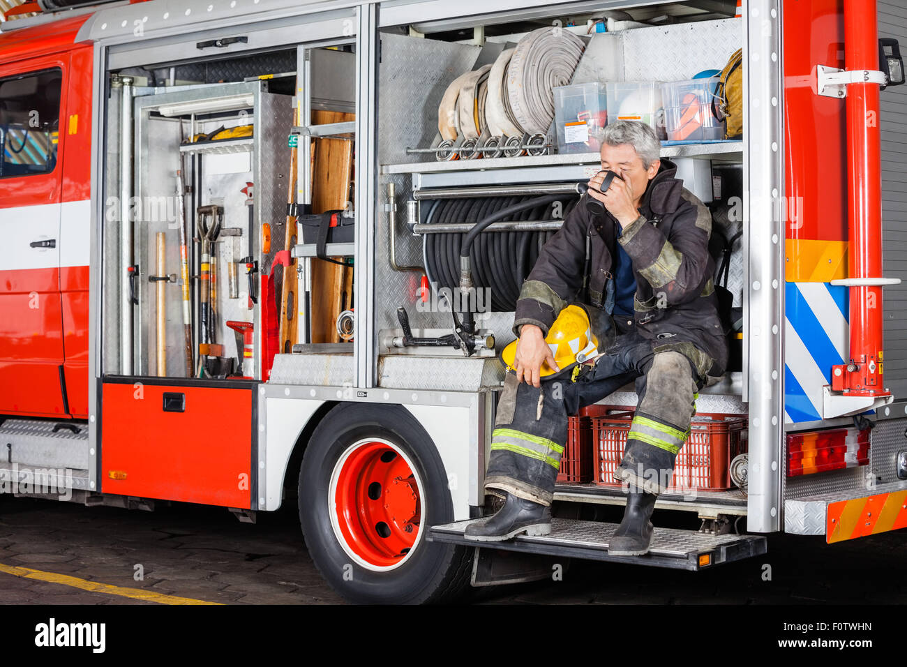 Fire Men Sitting In Fire Truck High Resolution Stock Photography and ...