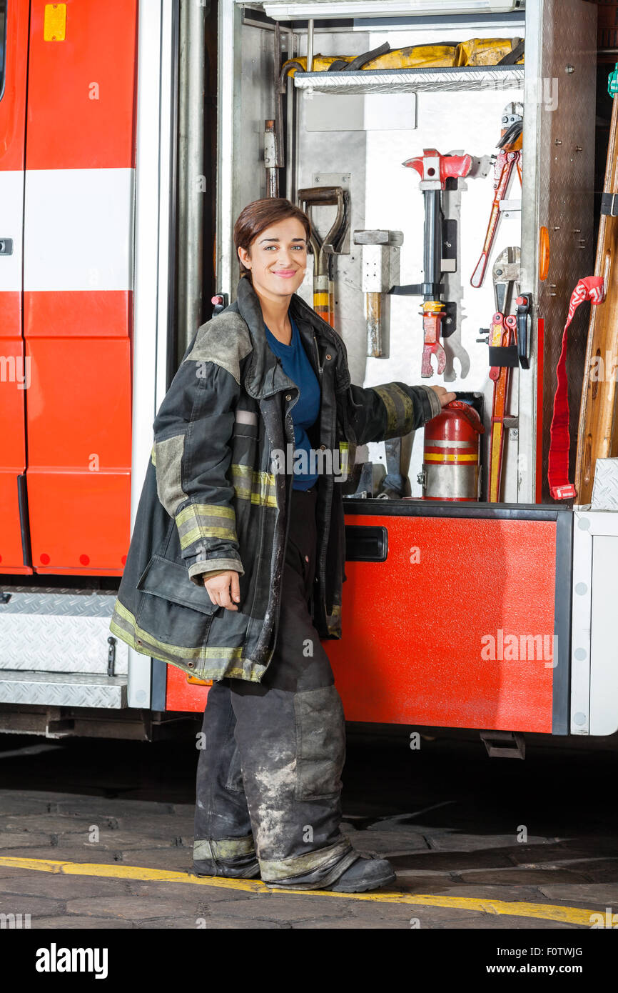 Smiling Firefighter Standing By Truck At Fire Station Stock Photo - Alamy