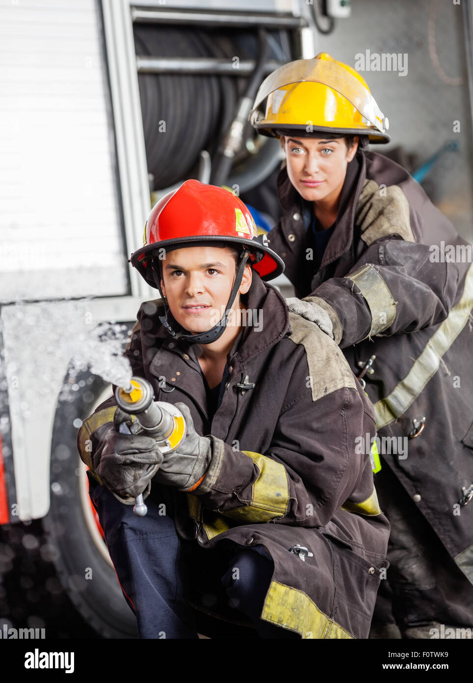 Firefighters Practicing At Fire Station Stock Photo - Alamy