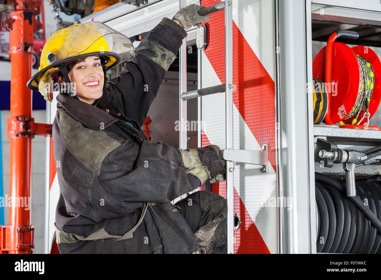 Smiling Firefighter Standing On Truck At Fire Station Stock Photo - Alamy