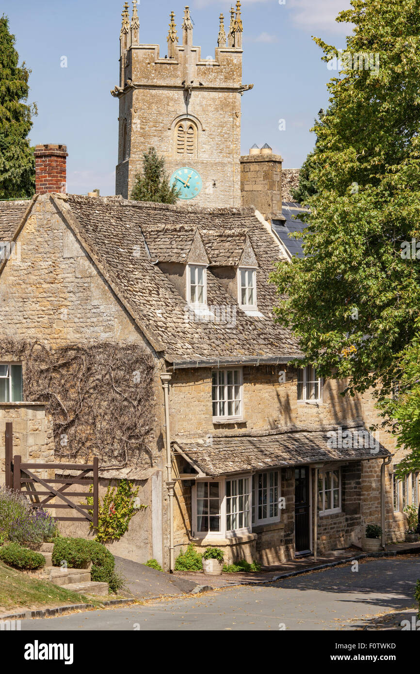 St James Church tower rises above attractive Cotswold cottages in ...