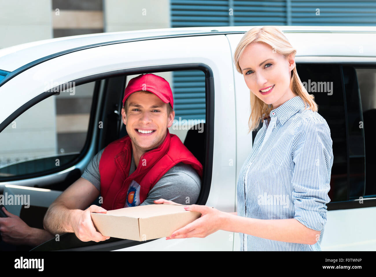 Courier Delivering Package By Van Stock Photo - Alamy