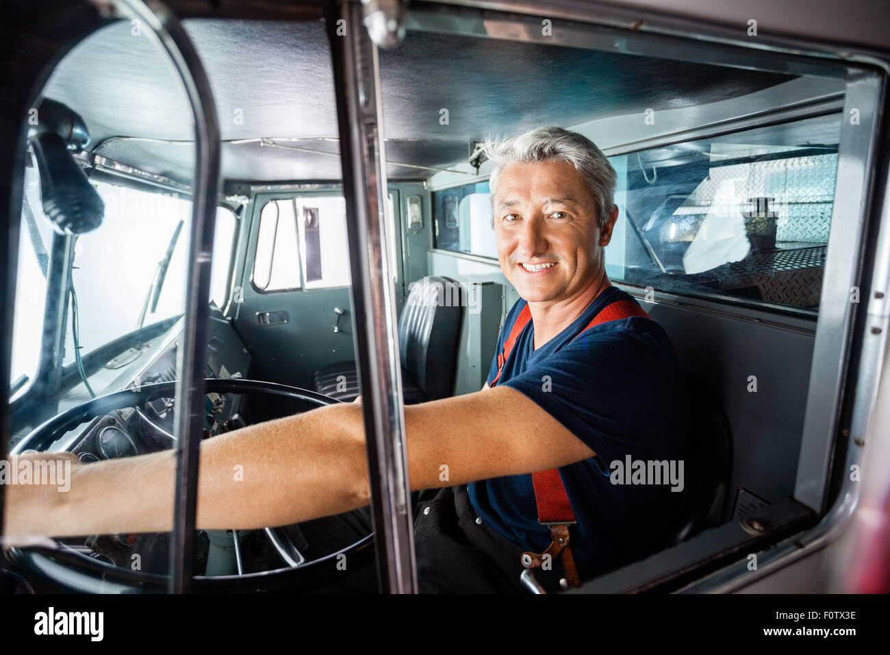 Happy Fireman Driving Firetruck Stock Photo - Alamy