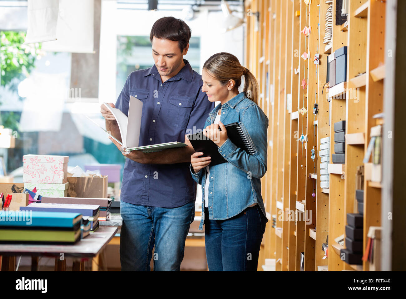 Couple Choosing Books In Store Stock Photo - Alamy