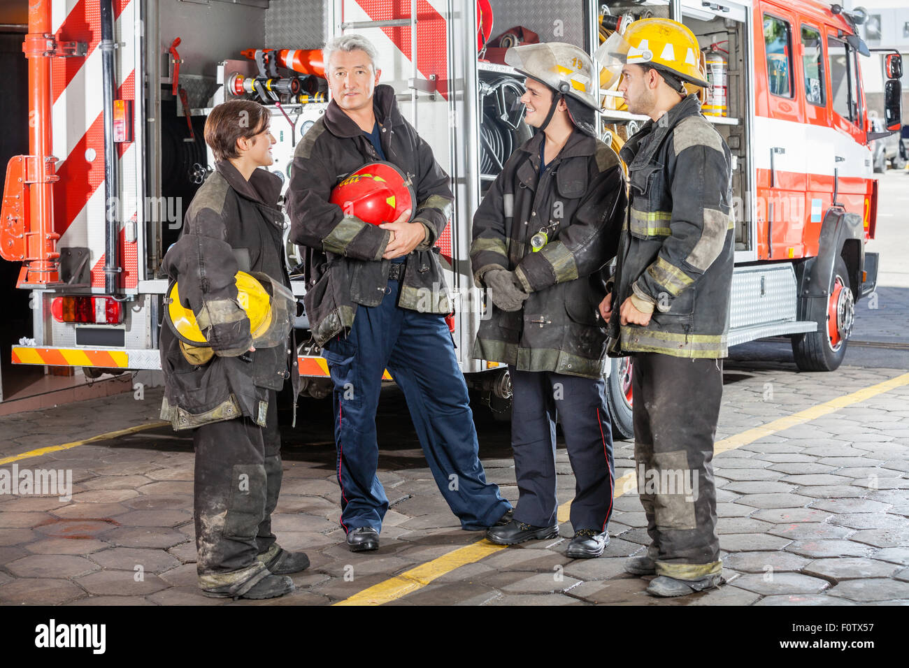 Portrait Of Confident Firefighter Standing With Team Stock Photo - Alamy