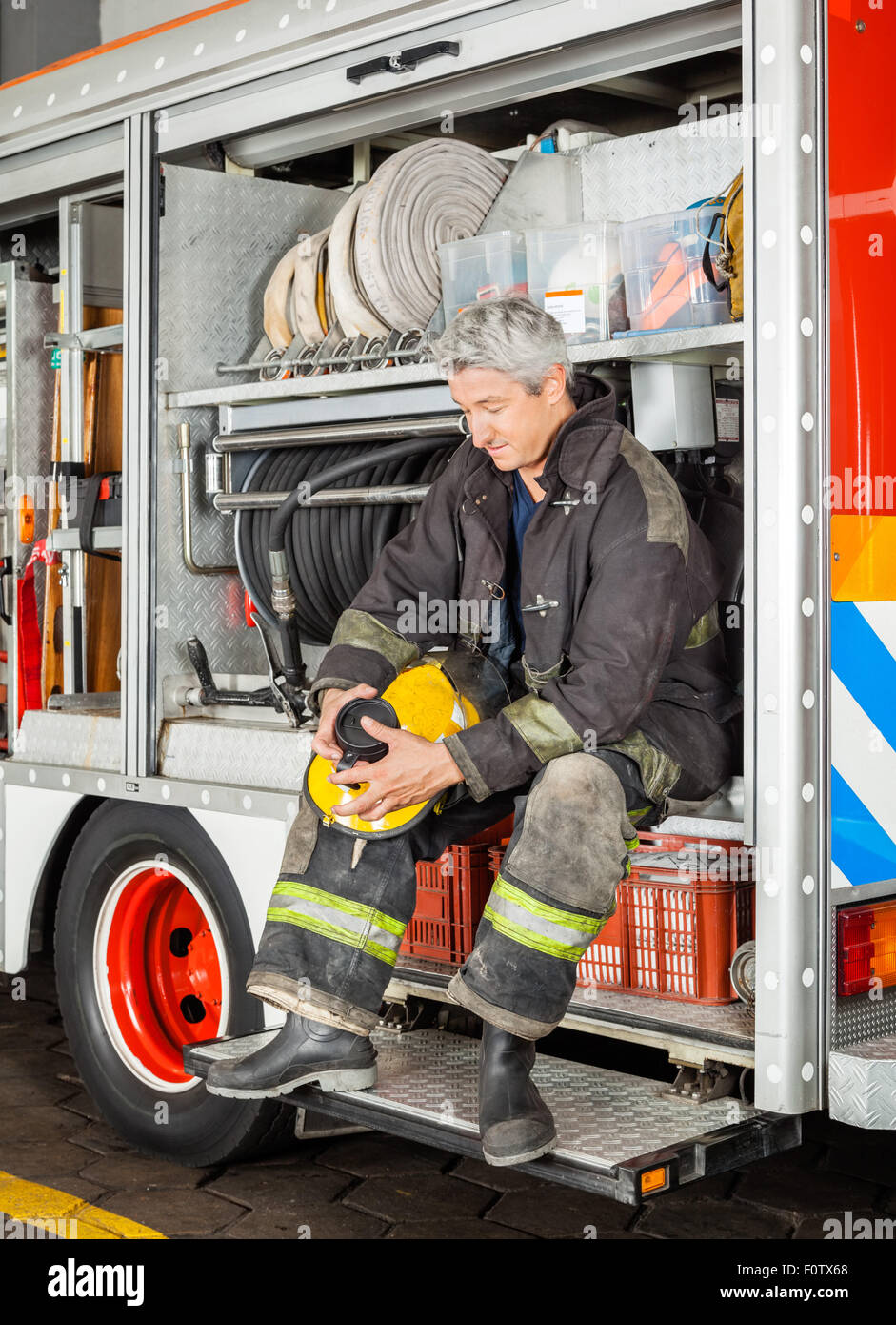 Fire men sitting in fire truck hi-res stock photography and images - Alamy