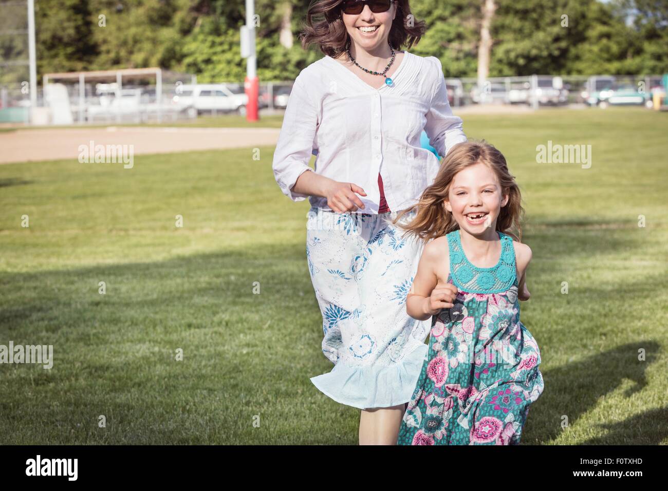 Mother and daughter running together Stock Photo - Alamy