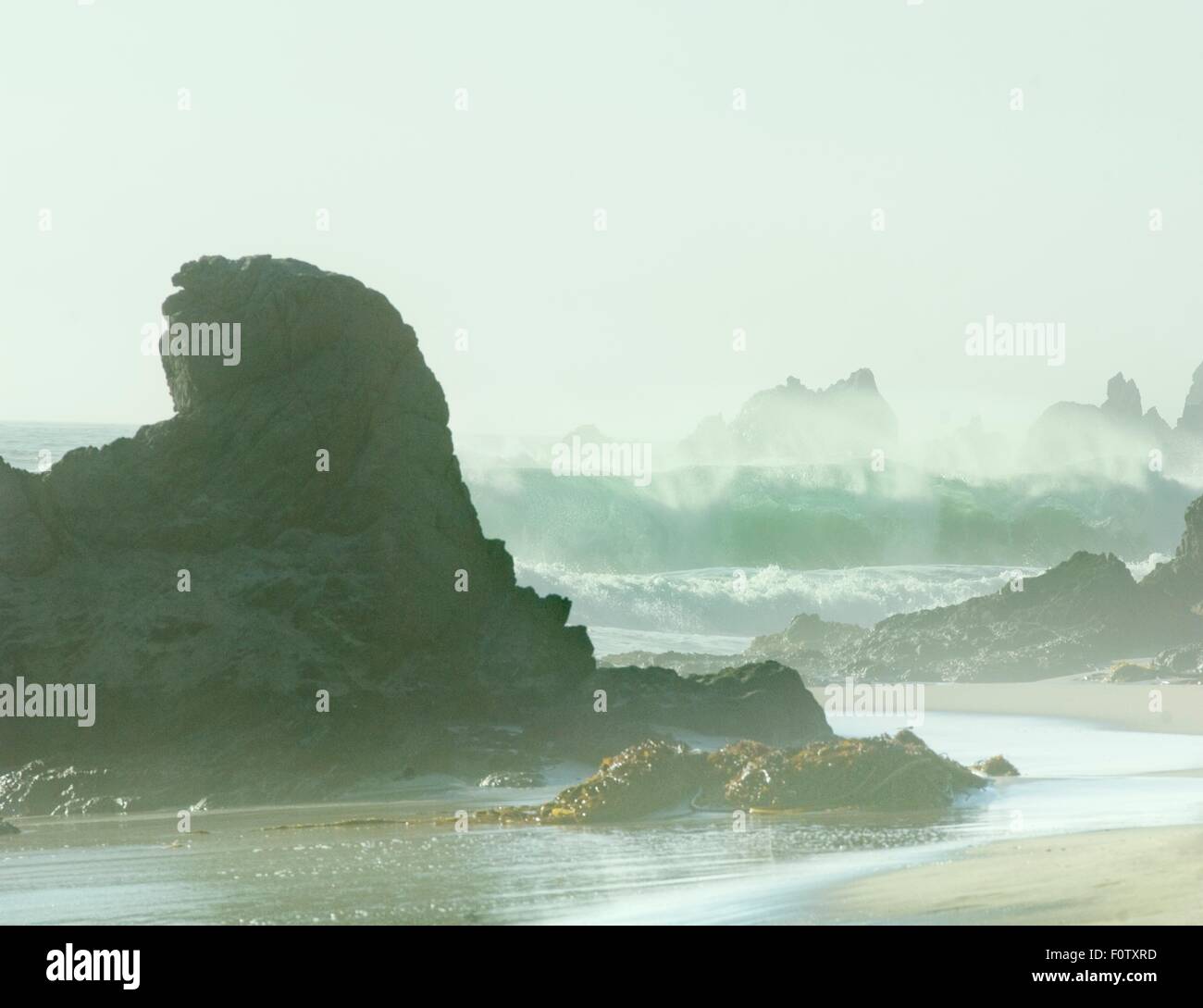 View of ocean waves and rock formations on beach, Big Sur, California ...